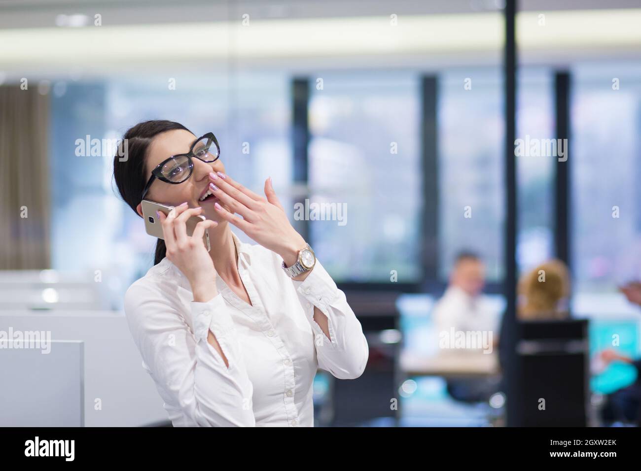 female manager using cell telephone in startup office interior Stock ...