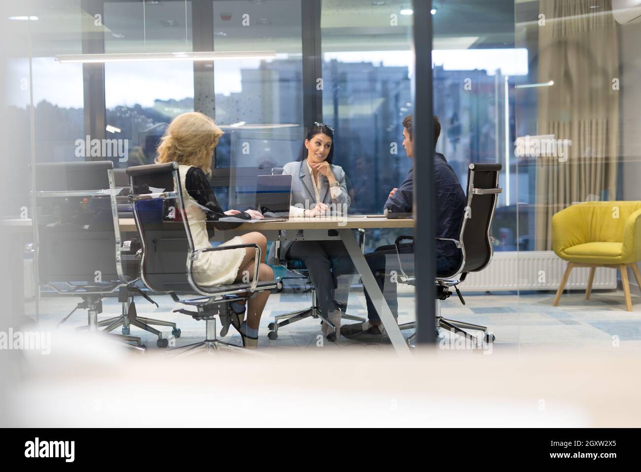 Group of a young business people discussing business plan at modern ...