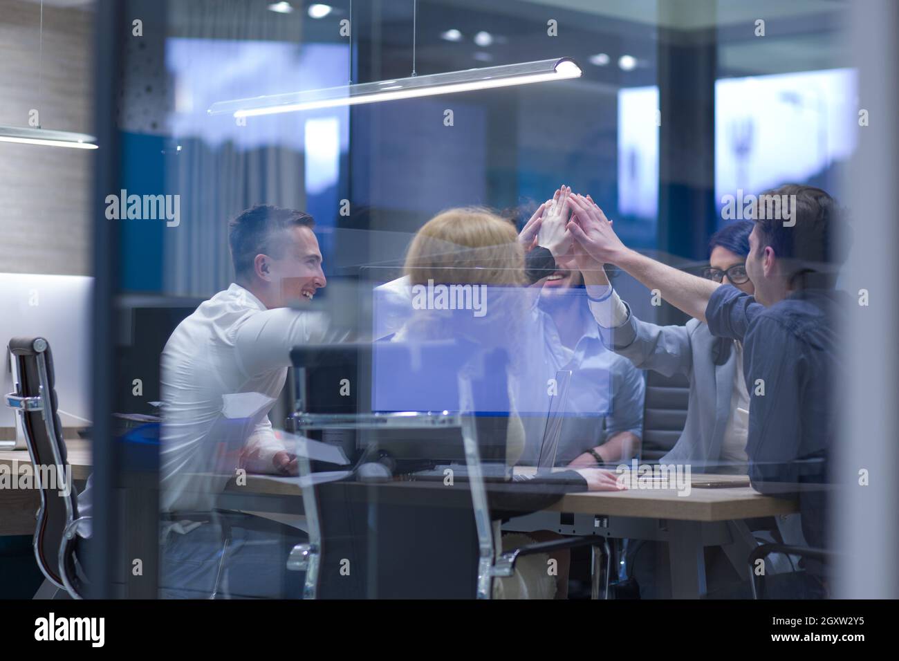 Group of young business people looking happy while celebrating success ...