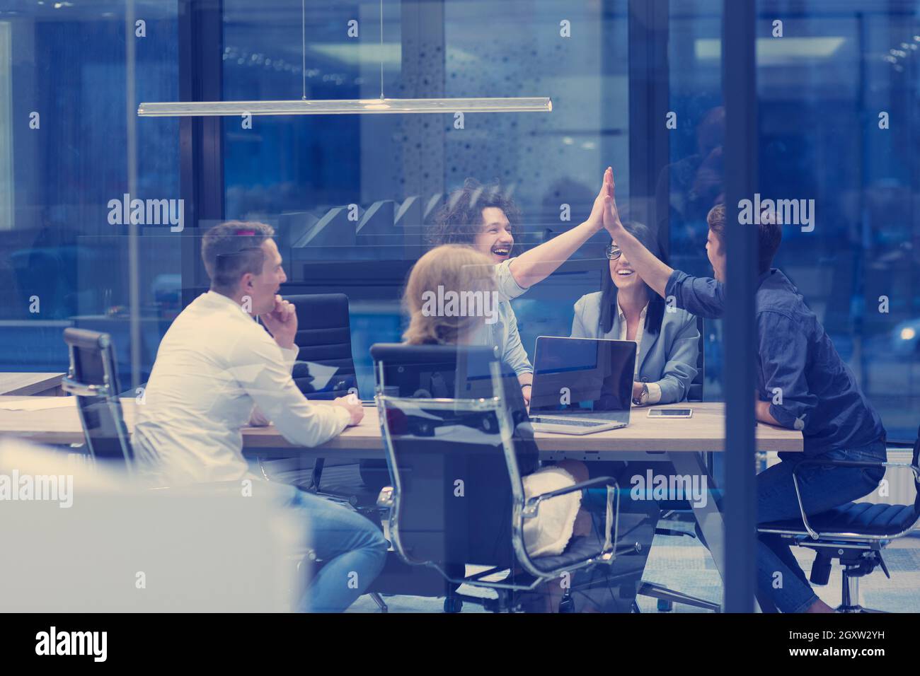 Group of young business people looking happy while celebrating success ...