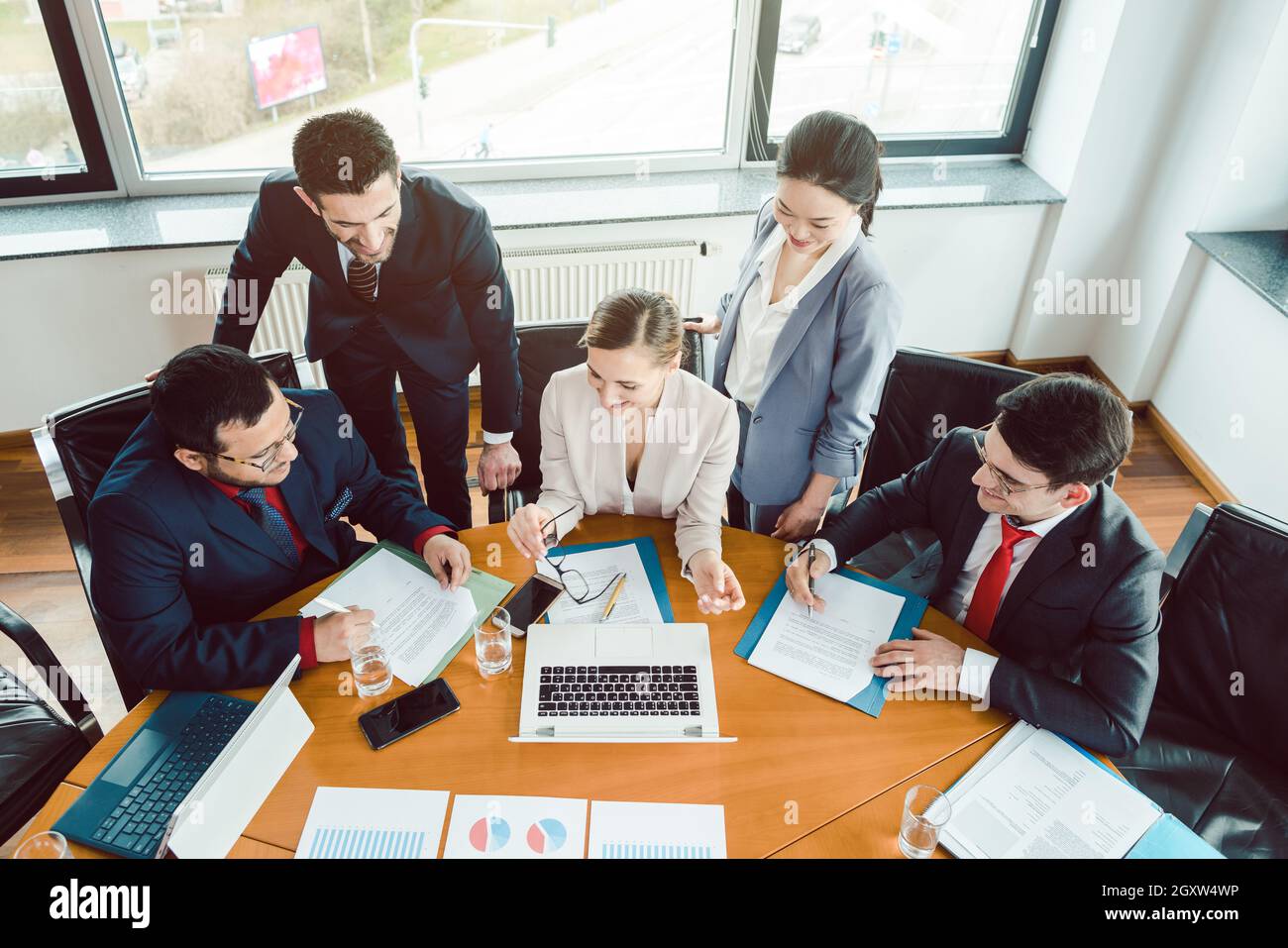 Five business people in a project meeting working together Stock Photo ...