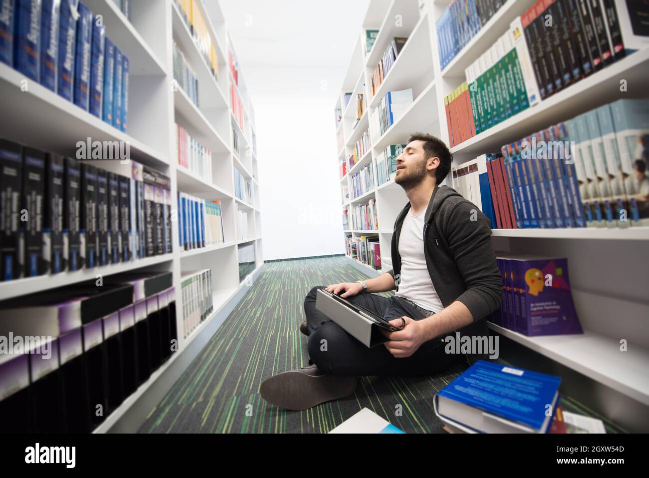 Student reading book in school library. Study lessons for exam. Hard ...
