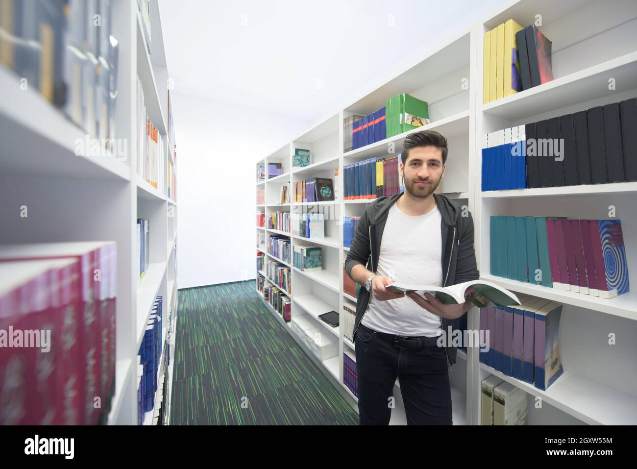 Student reading book in school library. Study lessons for exam. Hard ...