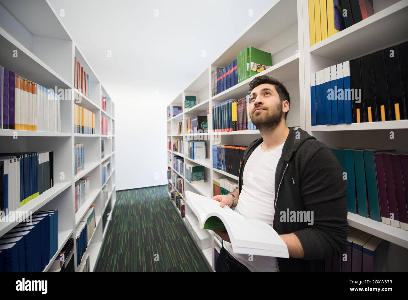 Student reading book in school library. Study lessons for exam. Hard ...