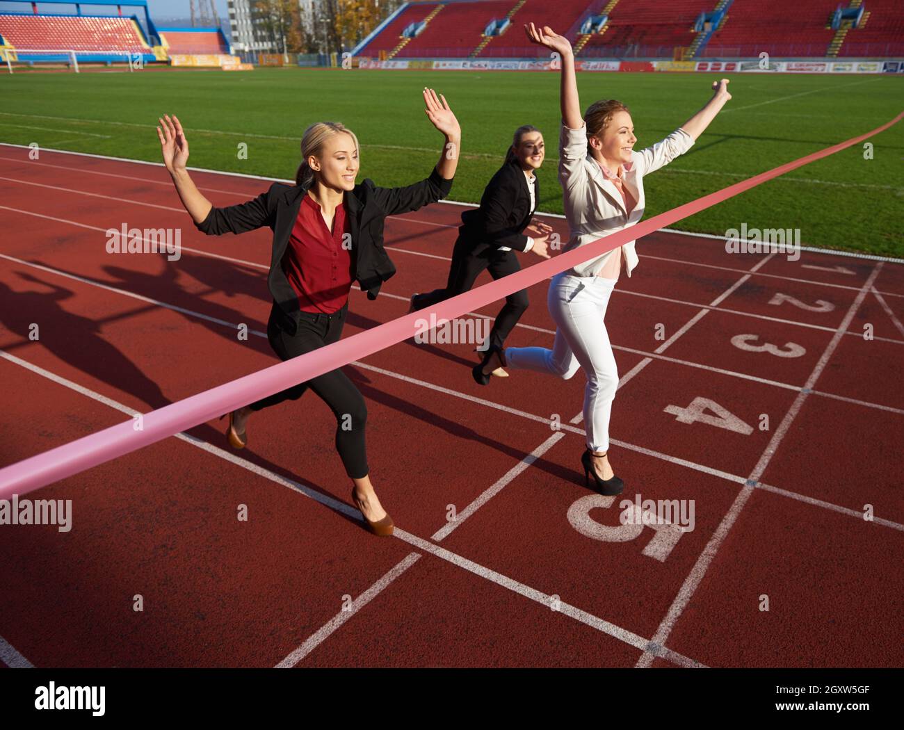 business people running together on racing track Stock Photo - Alamy