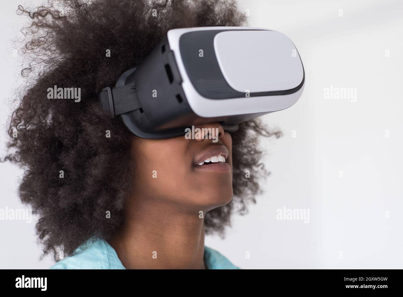Happy african american girl getting experience using VR headset glasses ...