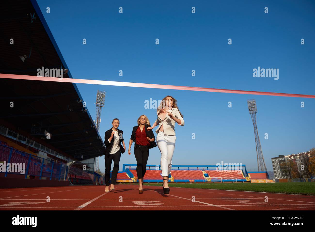 business people running together on racing track Stock Photo - Alamy