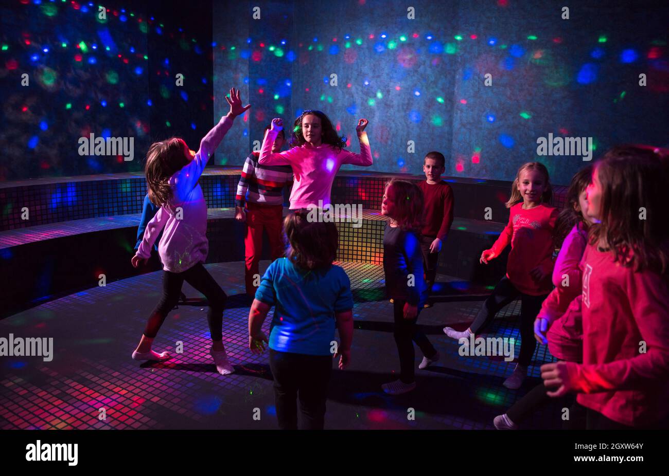 A group of joyful children happily spending time at Kids neon disco ...