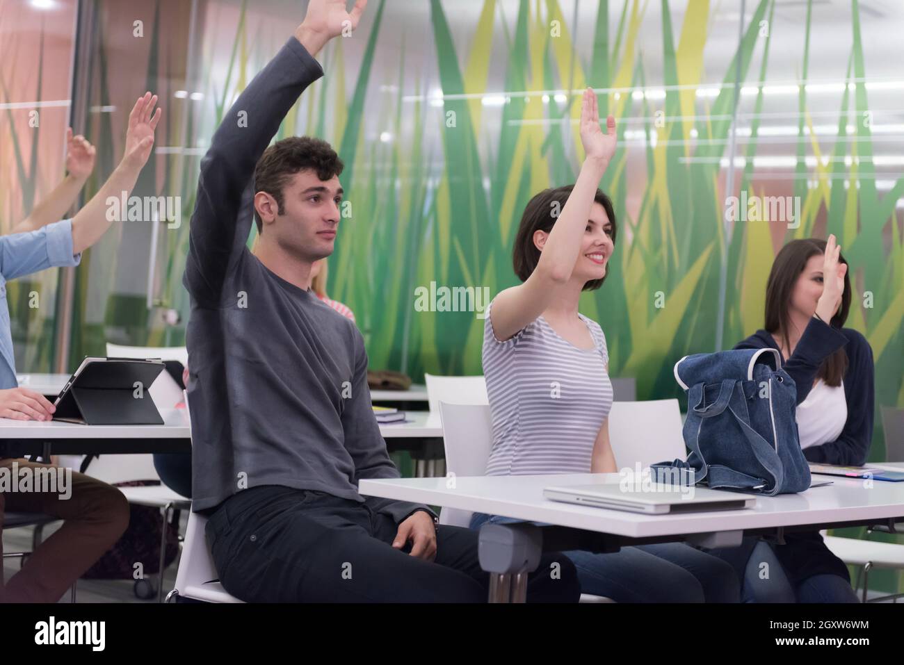 teacher teaching lessons, smart students group raise hands up in school ...