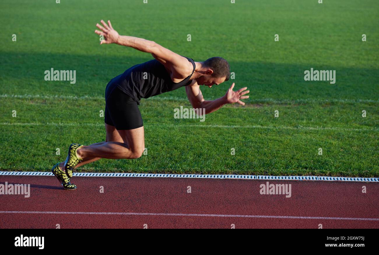 Sprinter leaving starting blocks on the running track. Explosive start ...