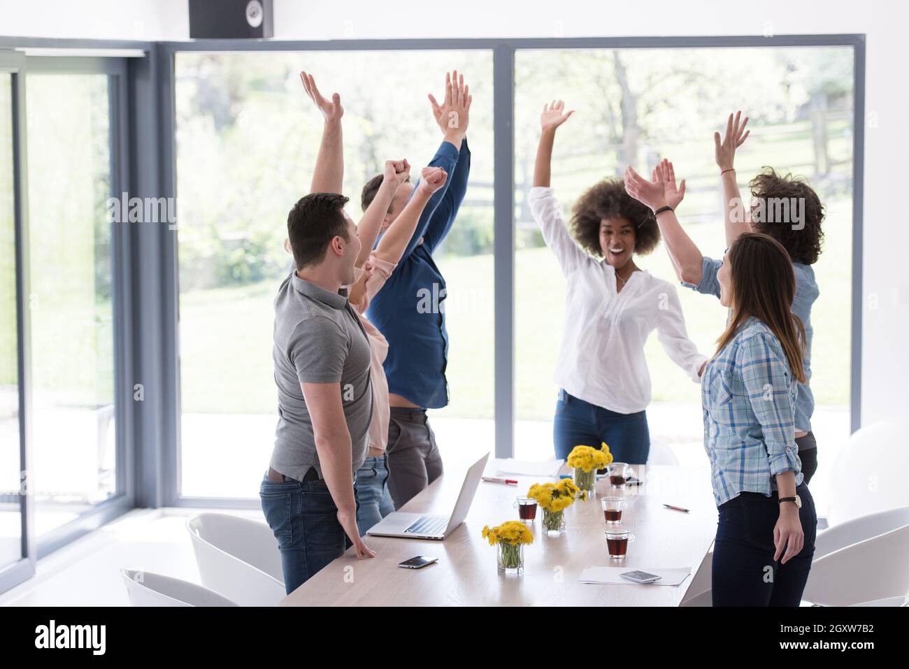 multiethnic Group of young business people looking happy while ...