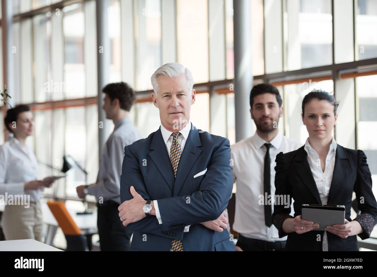 portrait of senior businessman as leader at modern bright office ...
