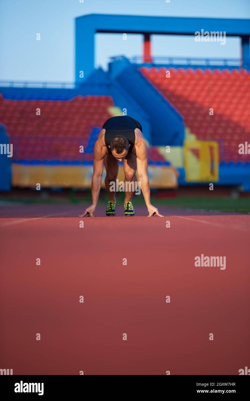 Sprinter leaving starting blocks on the running track. Explosive start ...