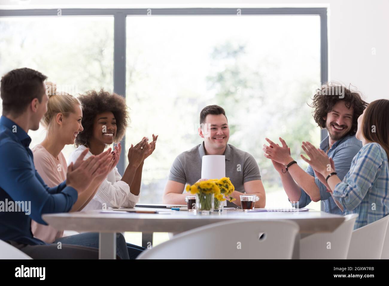 multiethnic Group of young business people looking happy while ...