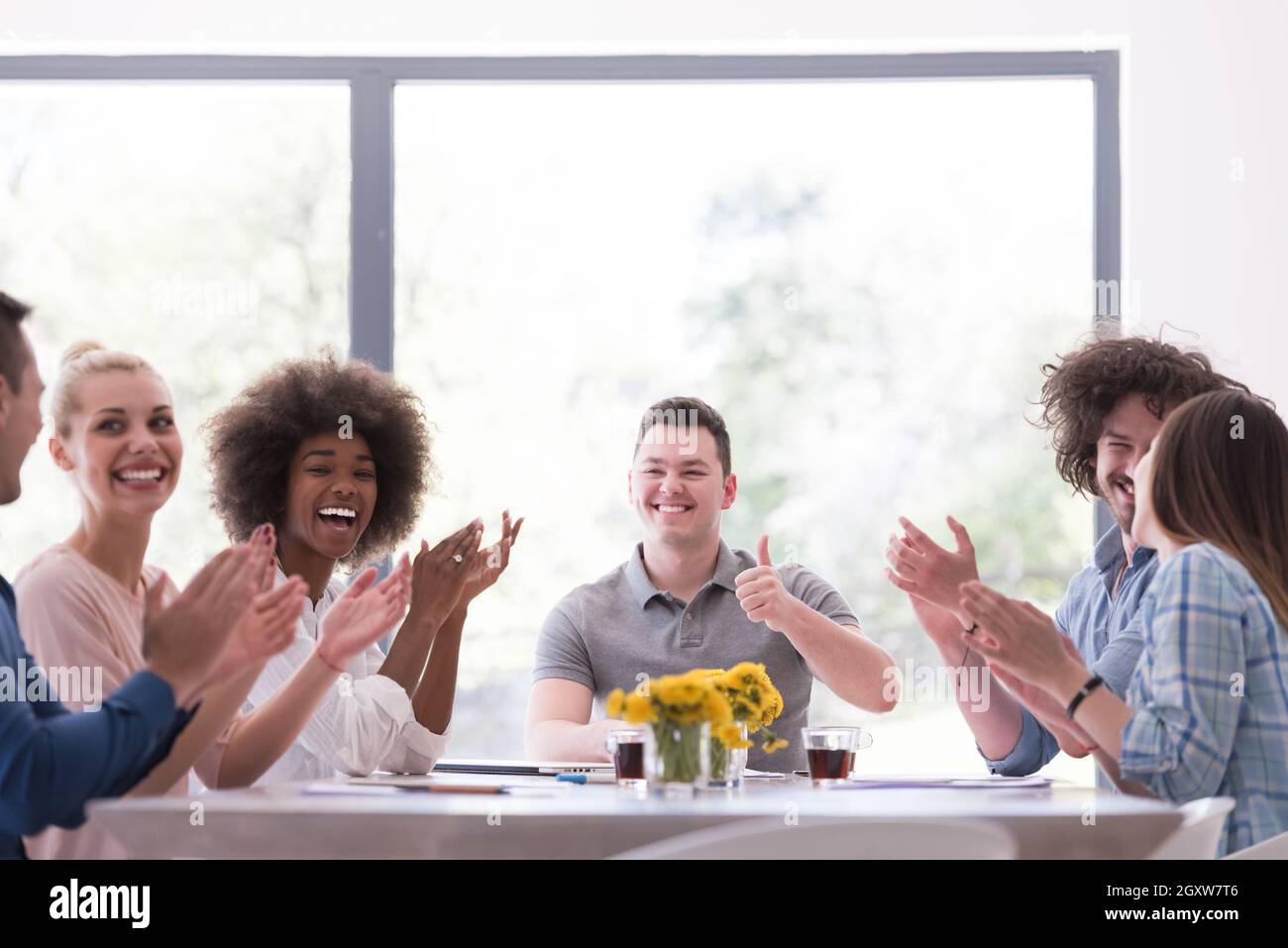 multiethnic Group of young business people looking happy while ...