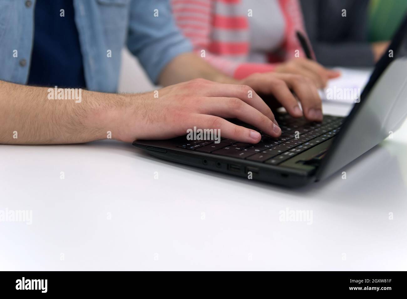 close up of young business man student student hands typing on laptop ...