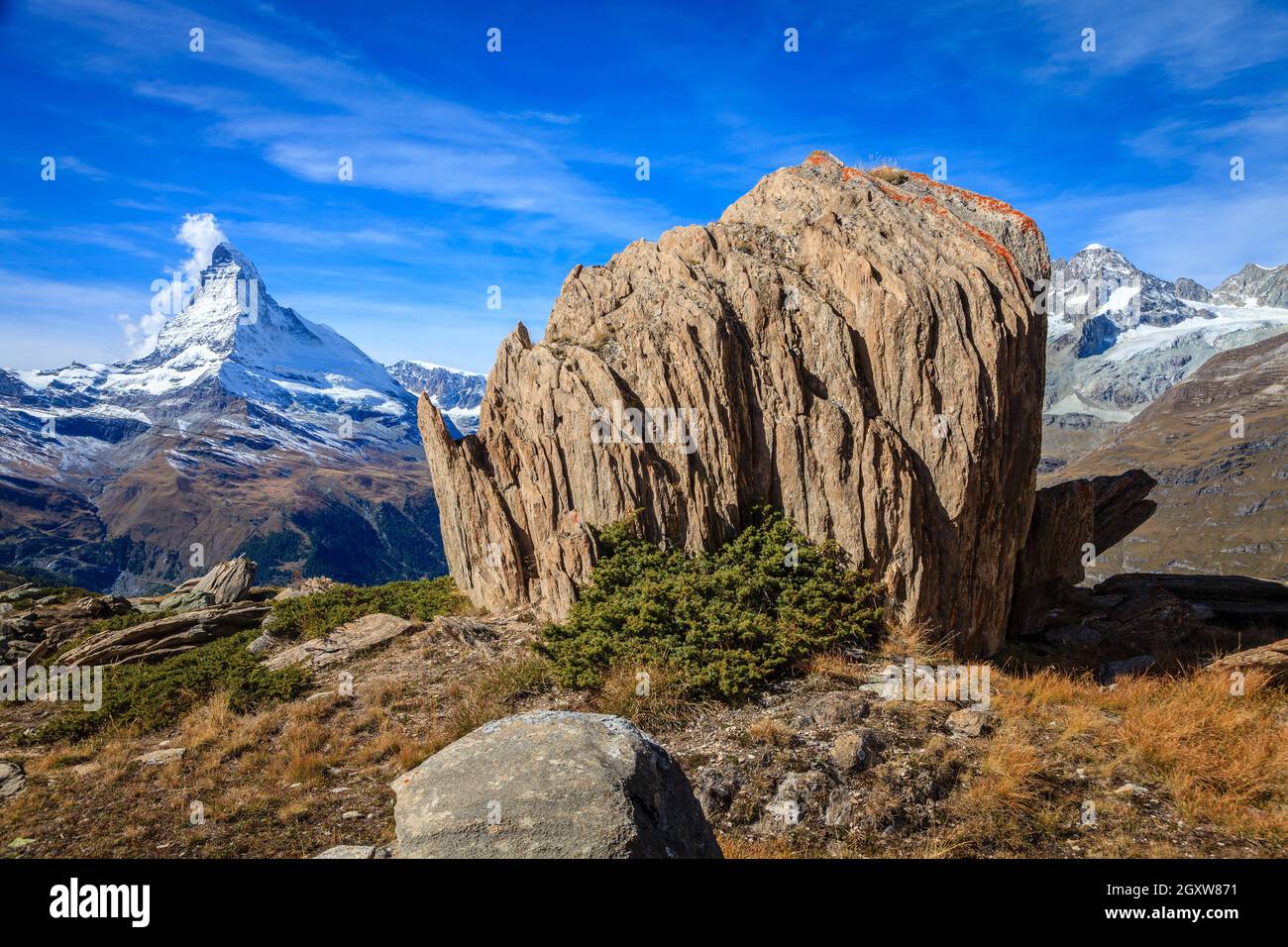 Layered rock outcropping in Swiss Alps with Matterhorn in the backdrop ...