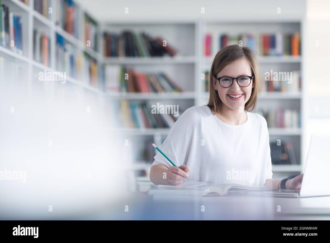 female student study in school library, using laptop and searching for ...