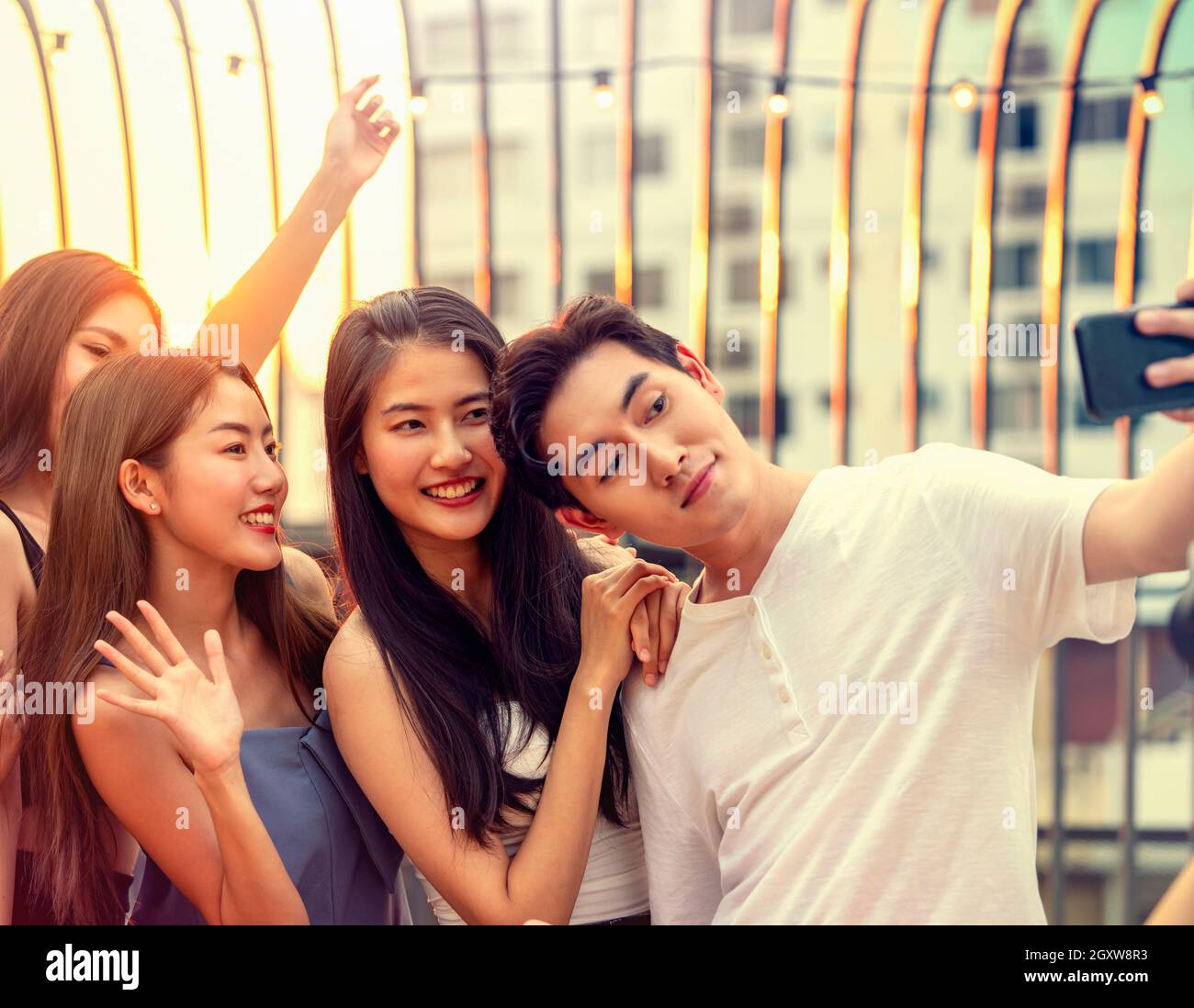 Photo of happy group of friends standing looking aside make a selfie ...