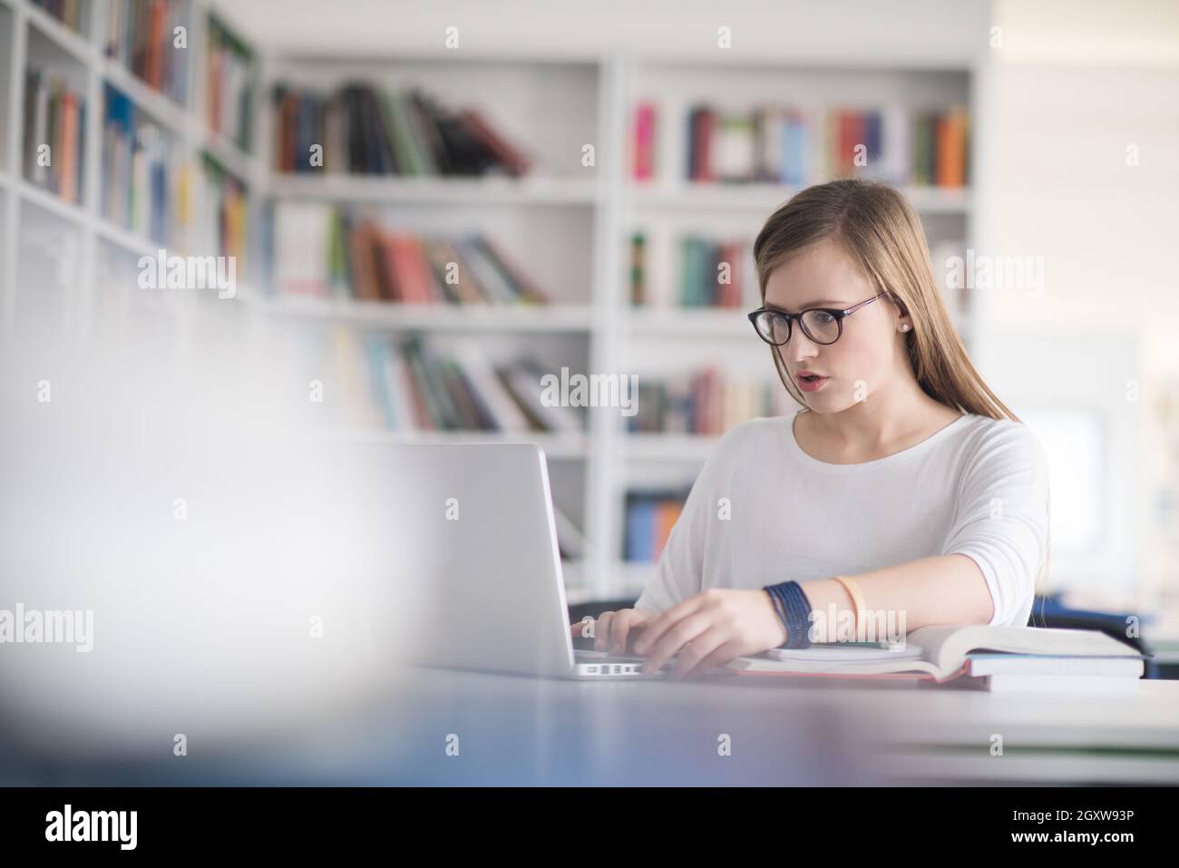 female student study in school library, using laptop and searching for ...