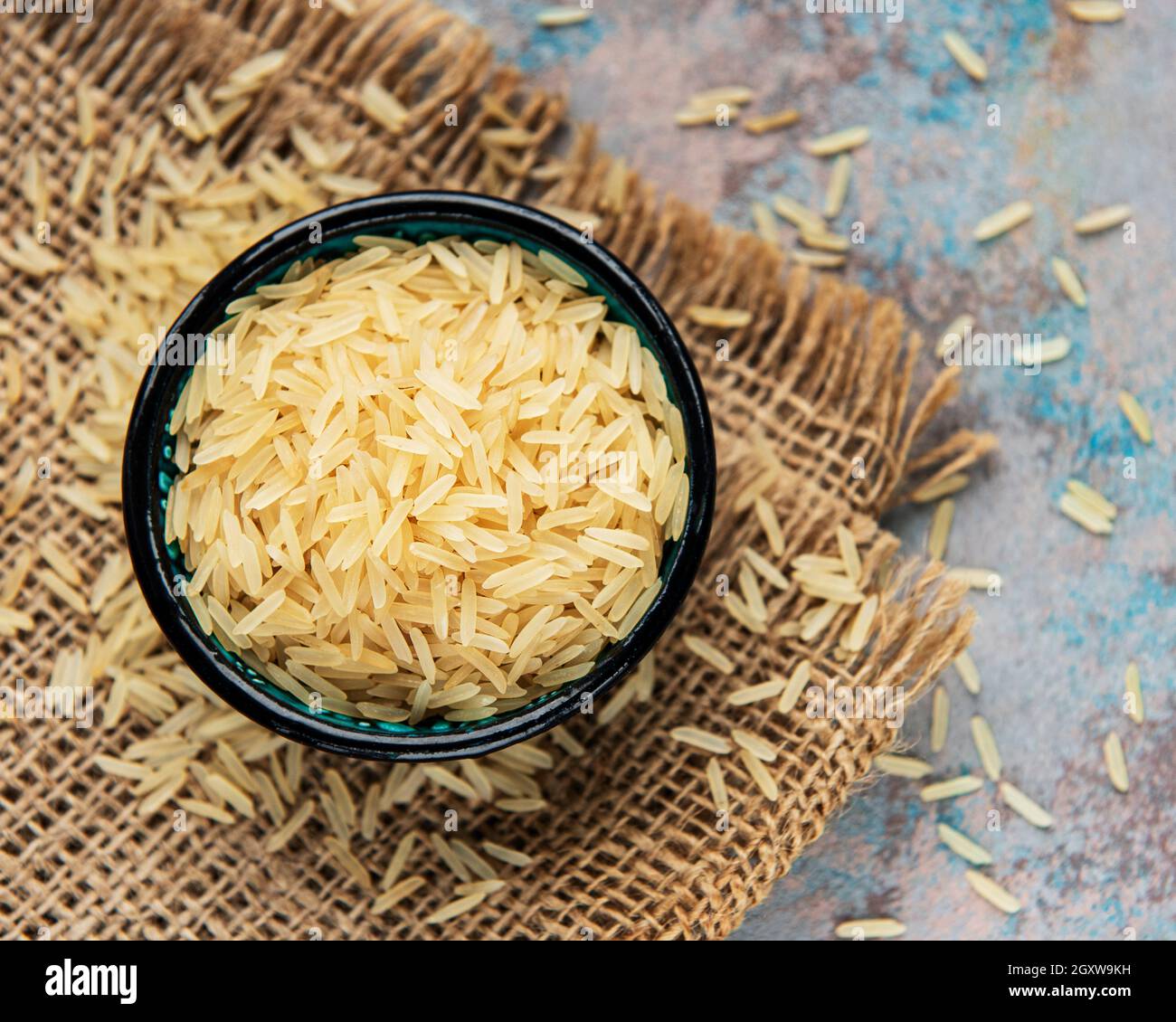 Uncooked basmati rice on a grey concrete background Stock Photo - Alamy