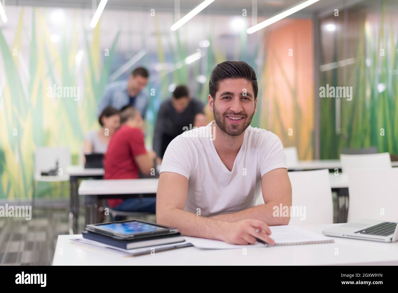 male student in classroom working homework and learning with laptop ...