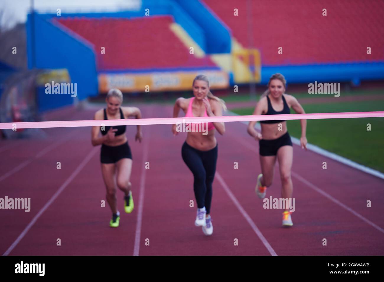 Female Runners Finishing athletic Race Together Stock Photo - Alamy