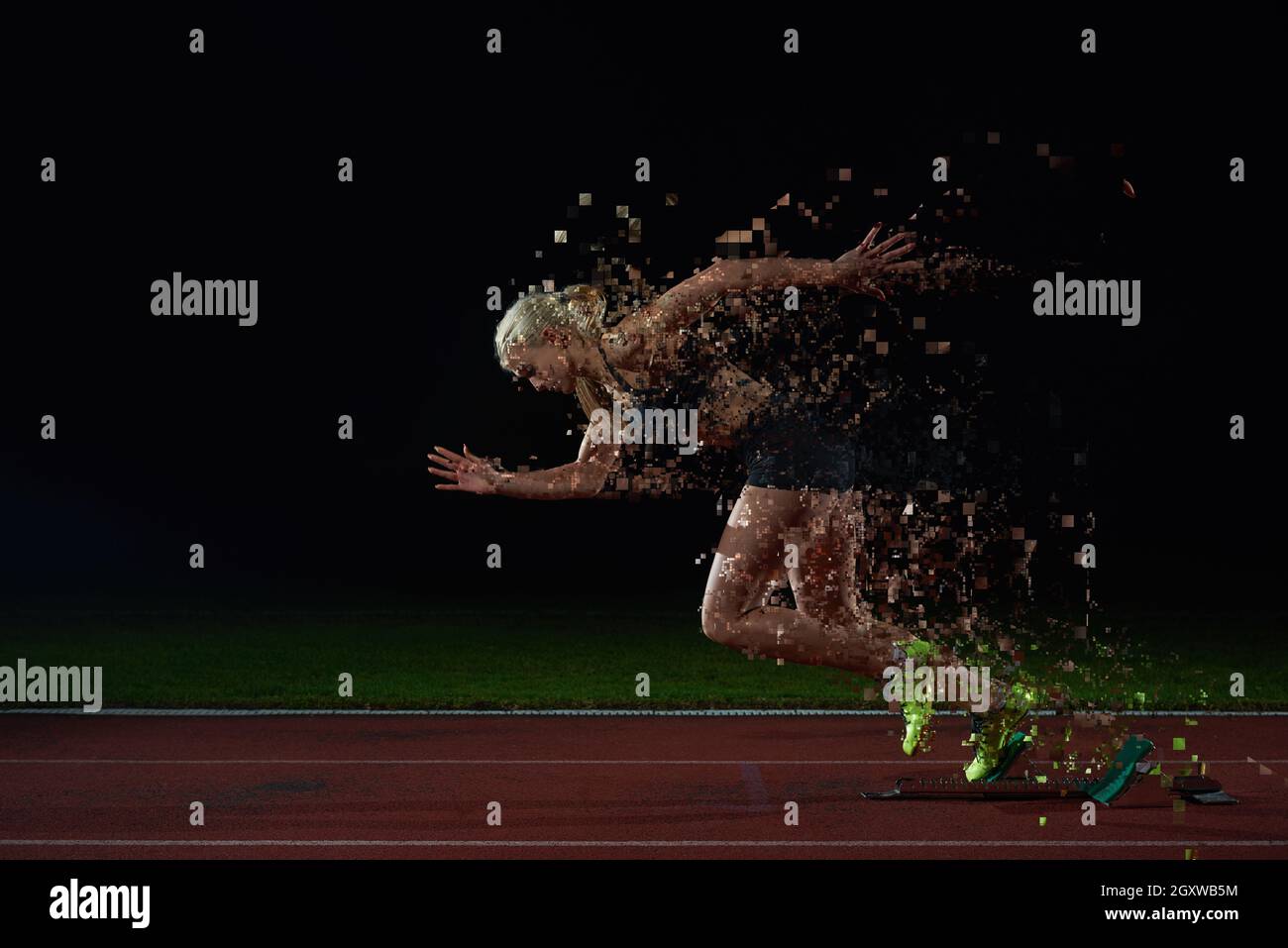 woman sprinter leaving starting blocks on the athletic track. Side view ...