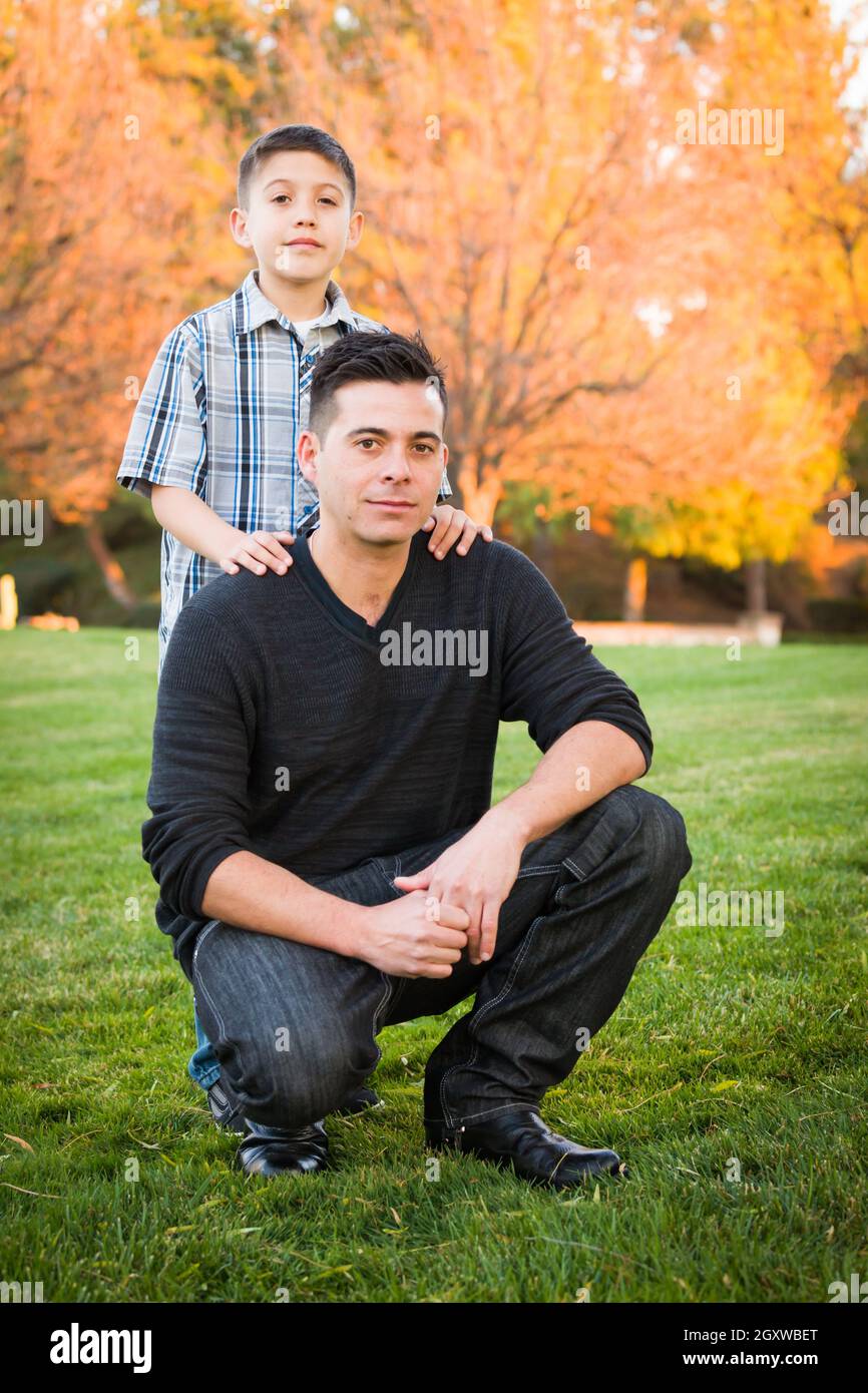Hispanic Father and Son Portrait Against Fall Colored Trees Stock Photo ...