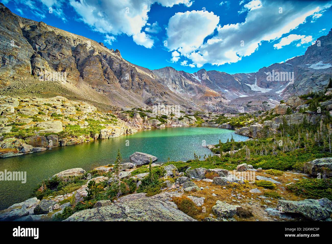 Snowy mountains surround large lake Stock Photo - Alamy