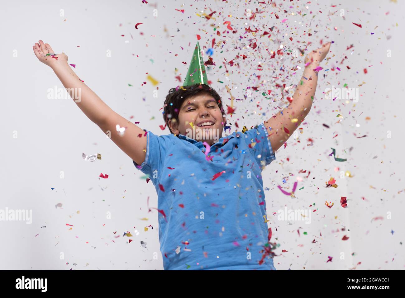 Happy kid celebrating party with blowing confetti Stock Photo - Alamy