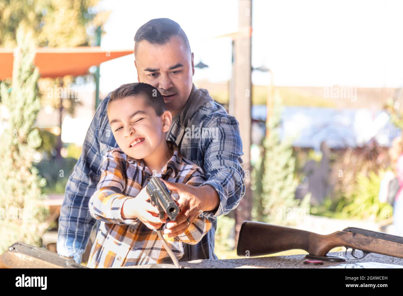 Mixed Race Father And Son At Fairground Shooting Range Stock Photo - Alamy