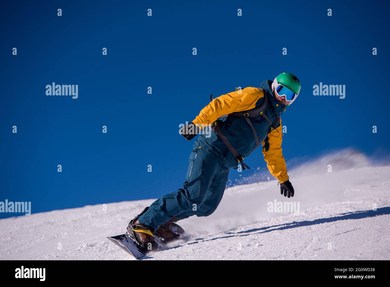 Young freestyle snowboarder running down the slope and ride free style ...
