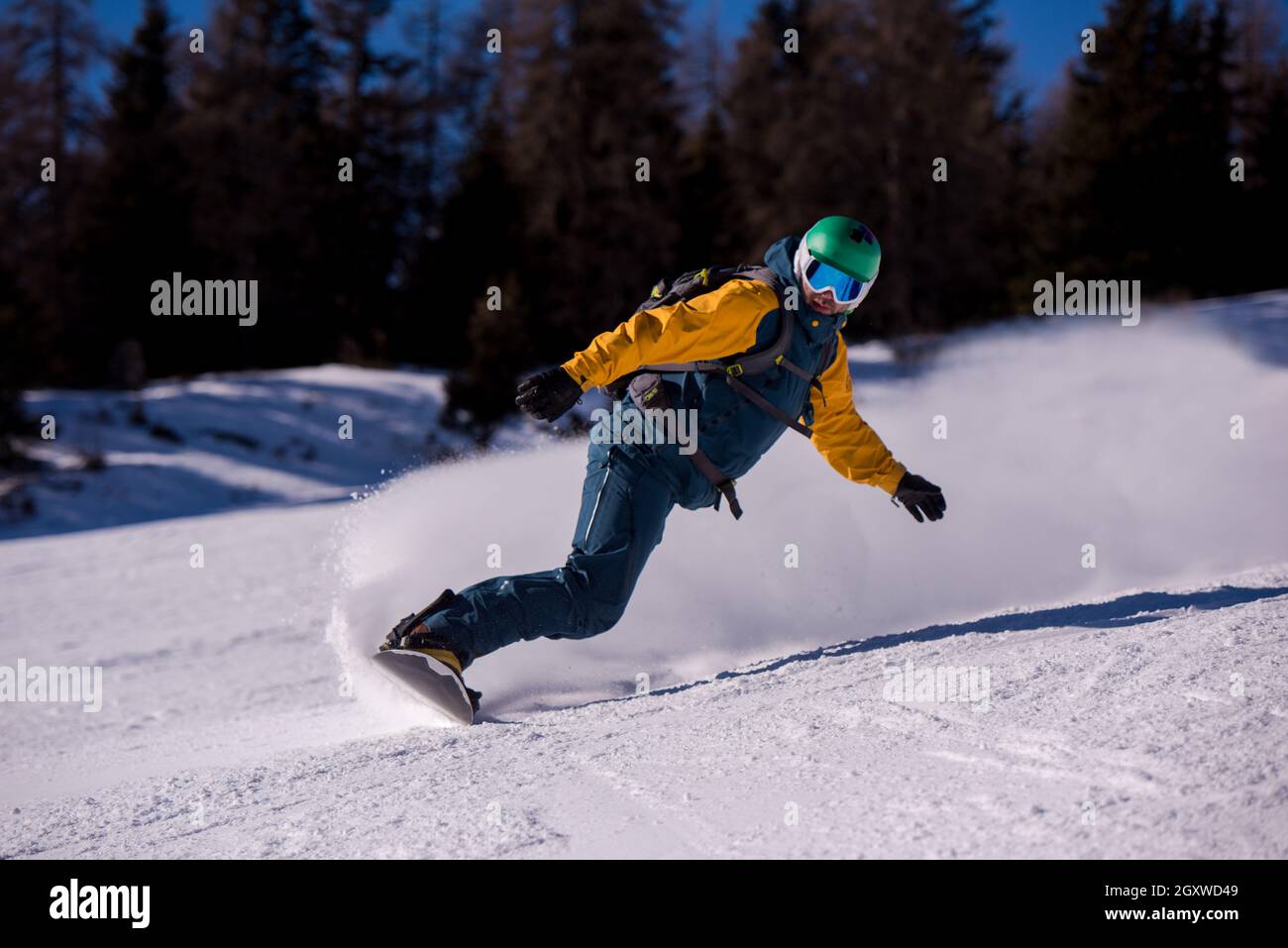 Young freestyle snowboarder running down the slope and ride free style ...