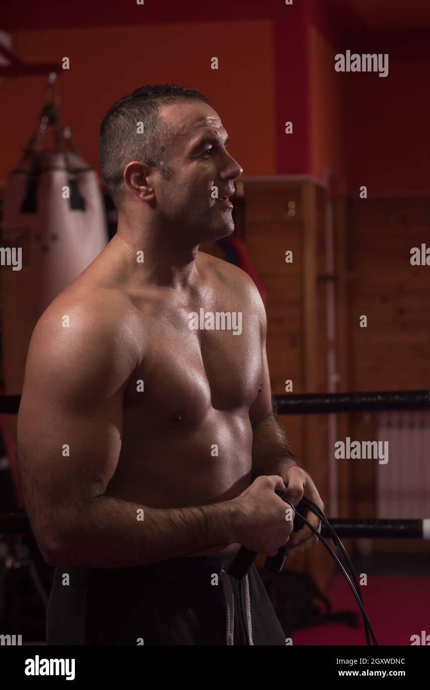 portrait of muscular professional kickboxer who standing in the ring ...