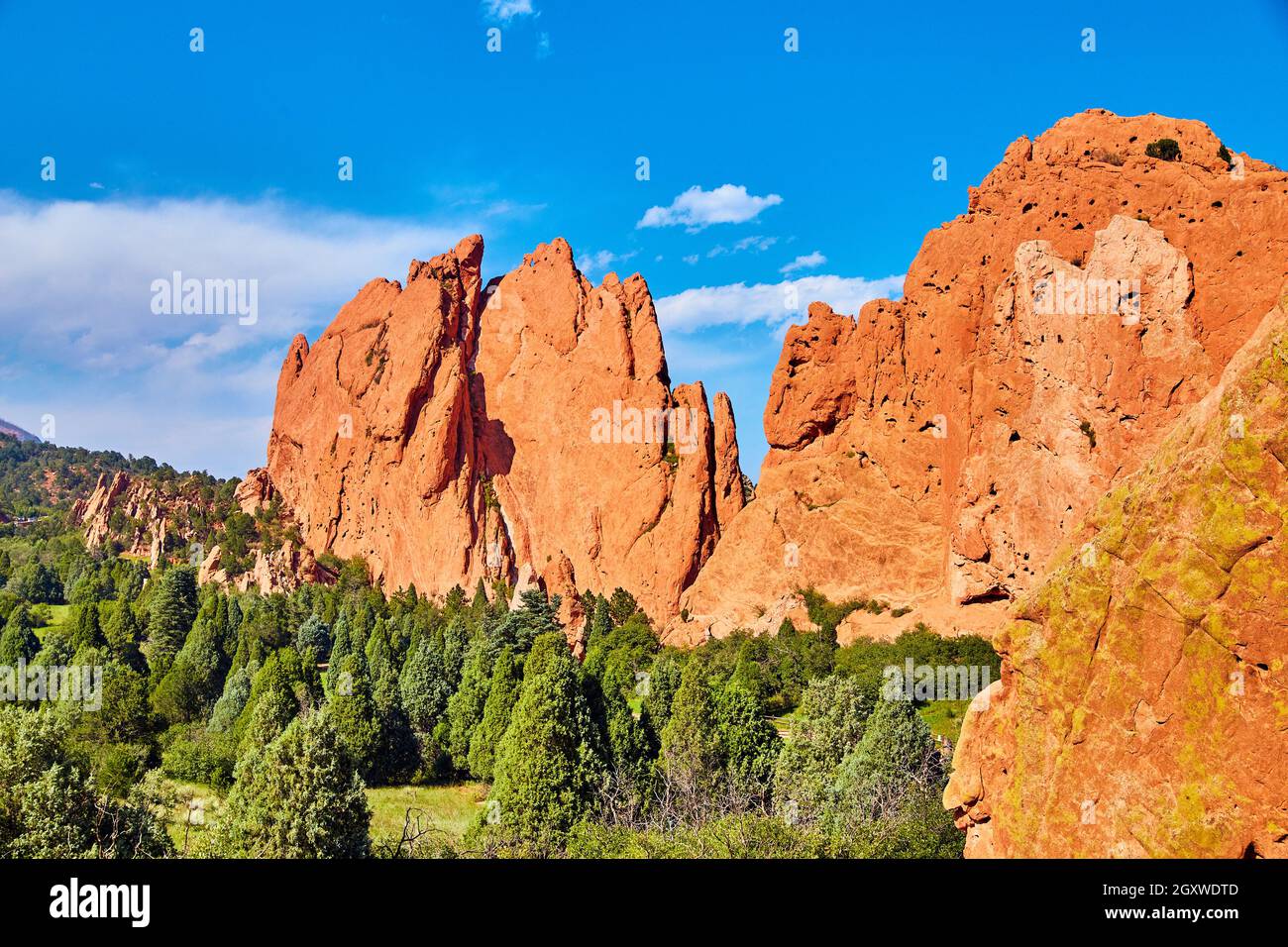 Giant outcroppings of red rocks in mountains and green forest Stock ...