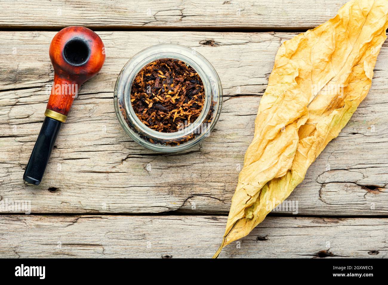 Tobacco pipe, tobacco leaf and pipe tobacco.Smoking pipe on rustic ...