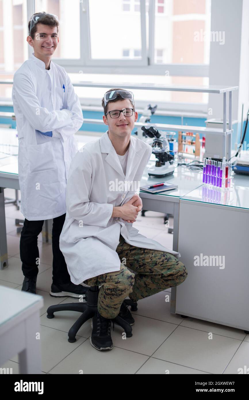 Group of young medical students doing research together in chemistry ...