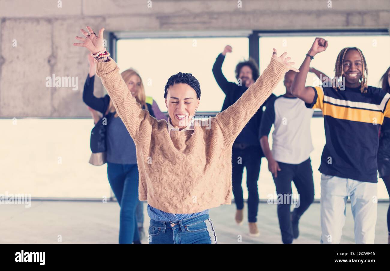 happy multiethnic business team dancing during moving in at new ...