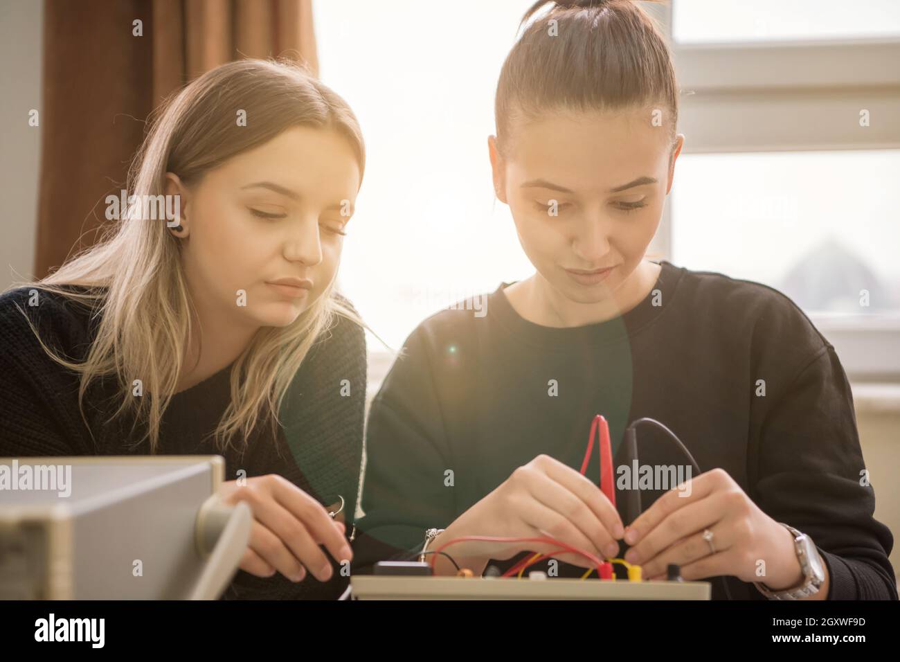 Group of young students doing technical vocational practice with ...