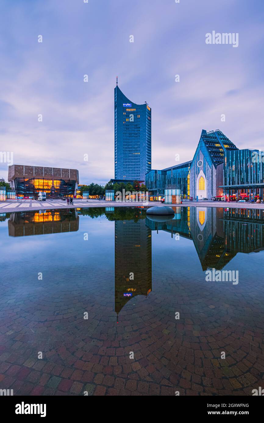Downtown in Leipzig in evening blue hour light with the City-Hochhaus ...