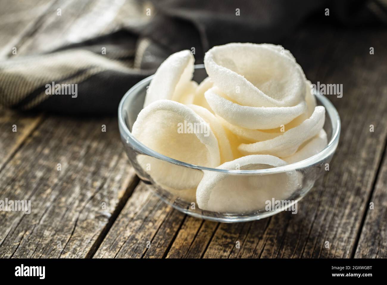 Puffed white snack chips. White potato chips on wooden table Stock ...