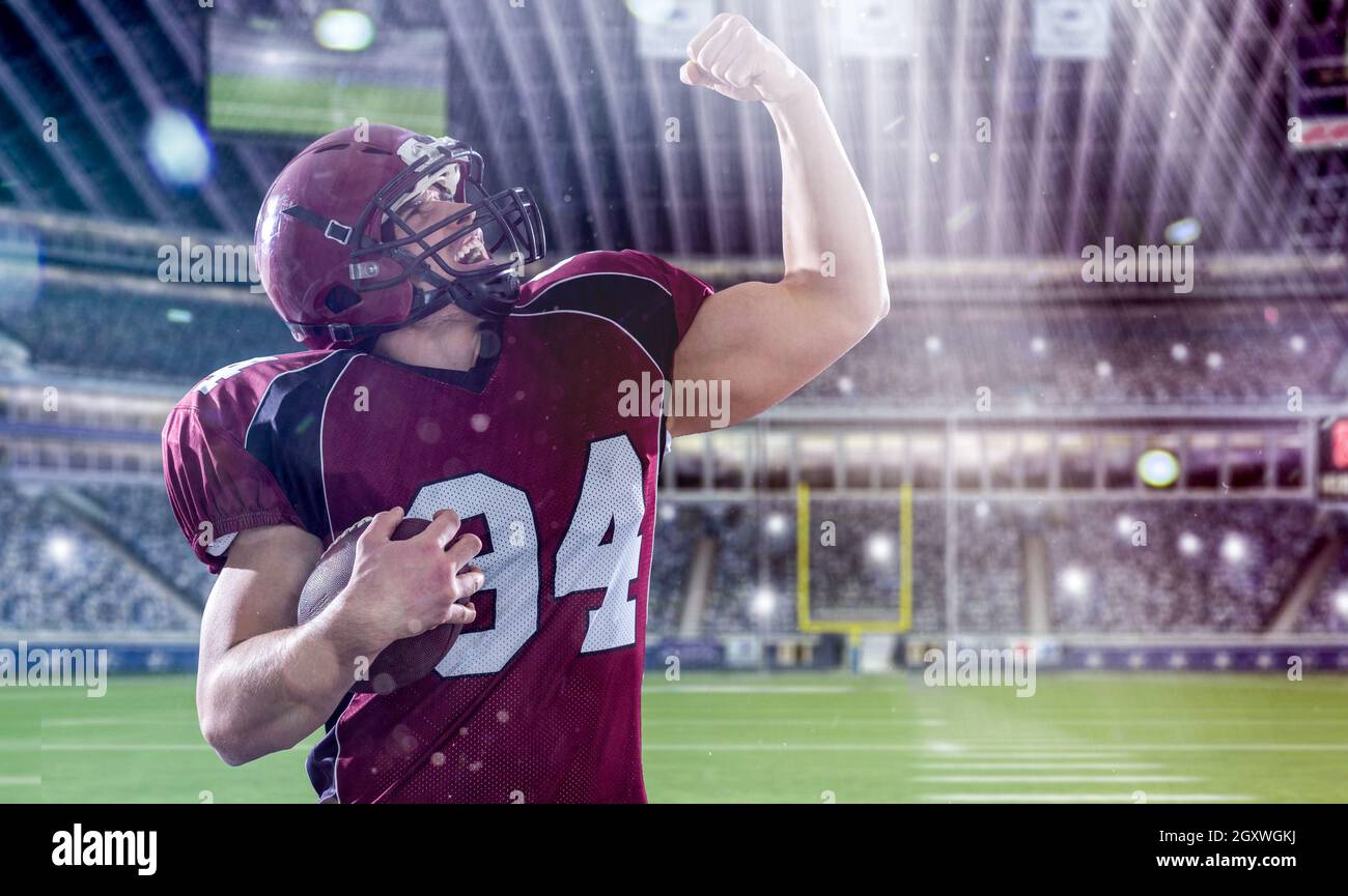 american football player celebrating touchdown on big modern stadium ...