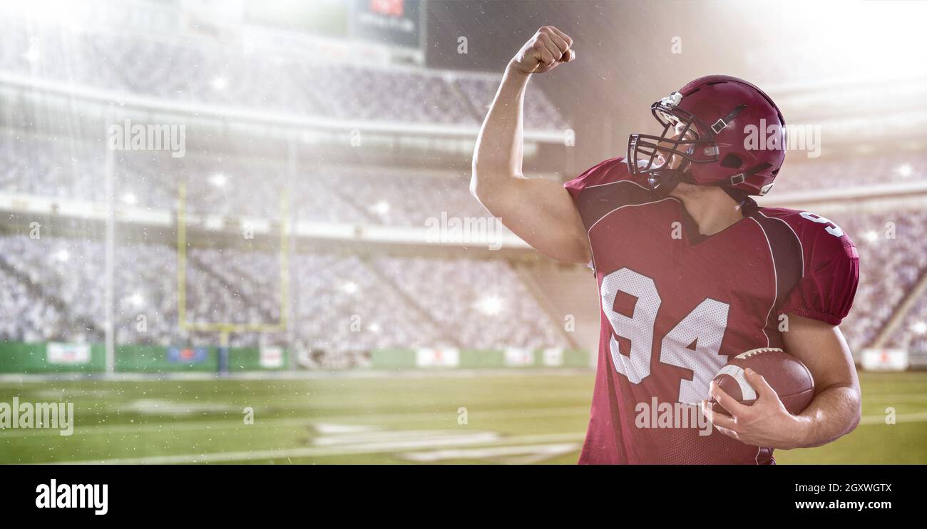 american football player celebrating touchdown on big modern stadium ...