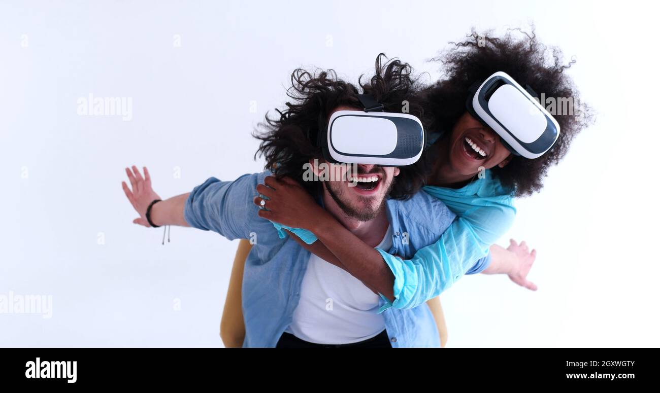 Happy multiethnic couple getting experience using VR headset glasses of ...