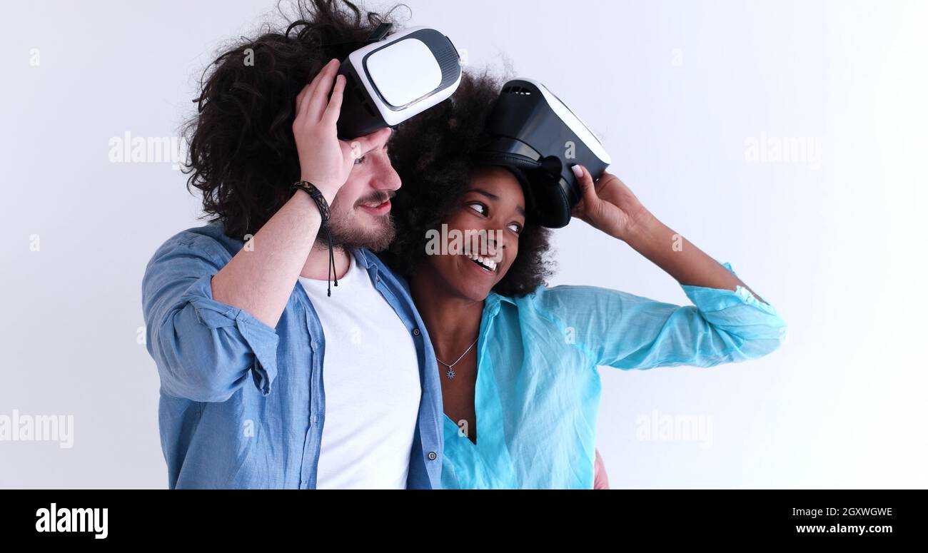 Happy multiethnic couple getting experience using VR headset glasses of ...