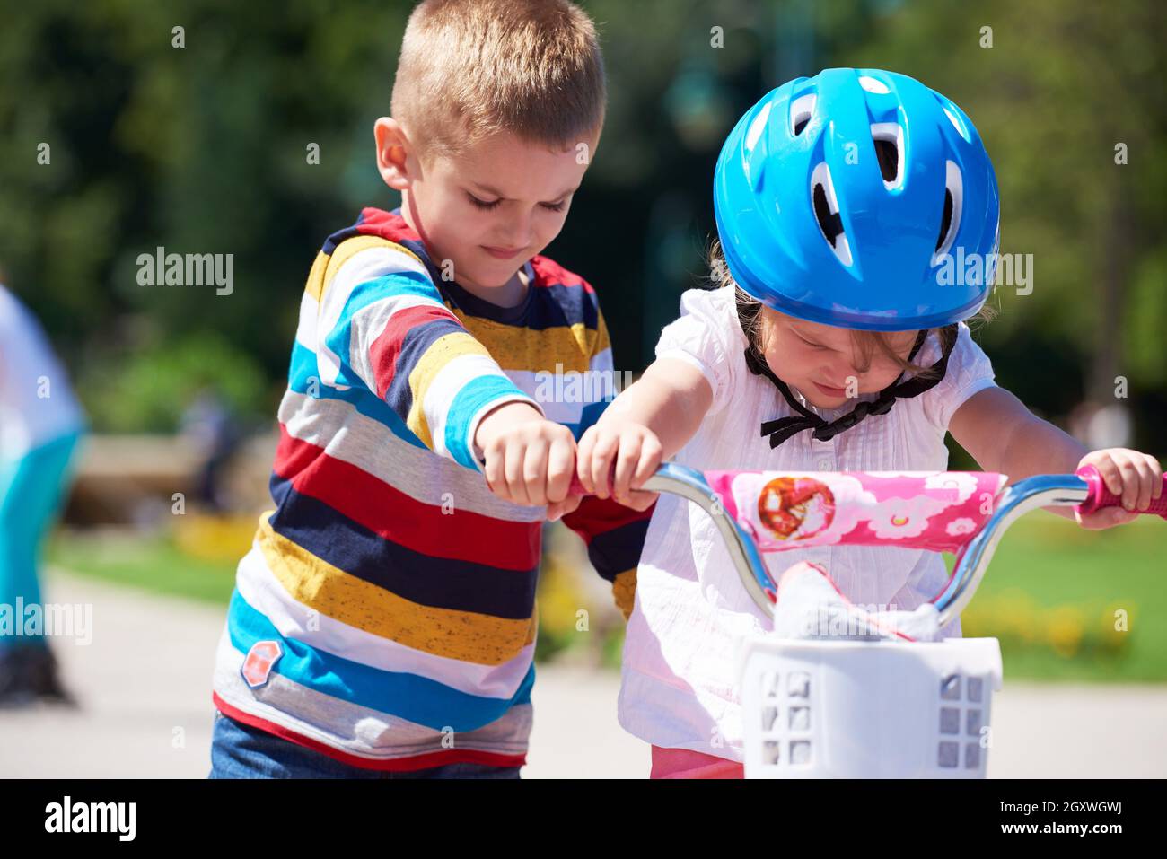 Happy childrens outdoor, brother and sister in park have fun. Boy and girl in park learning to ...