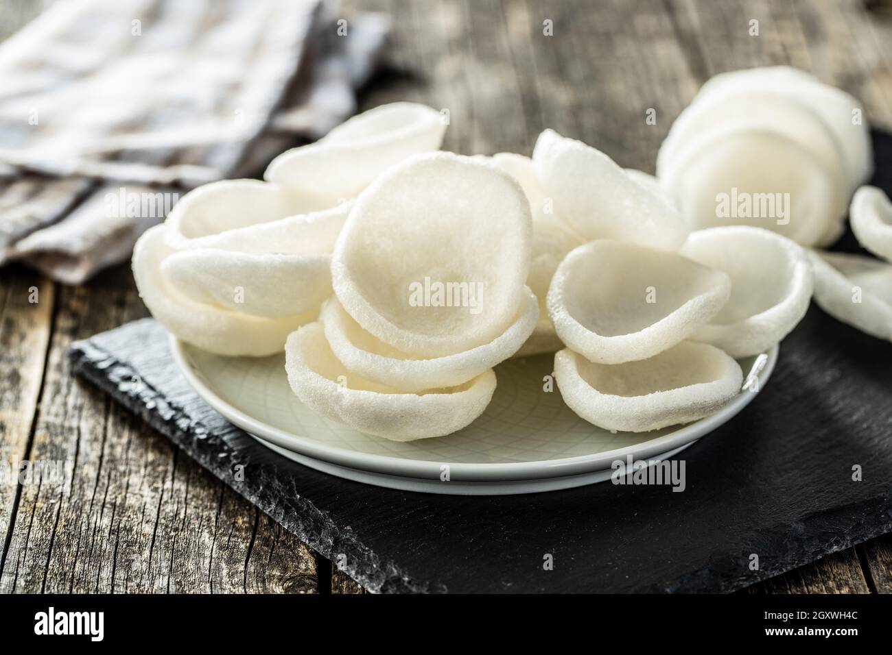 Puffed white snack chips. White potato chips on wooden table Stock ...