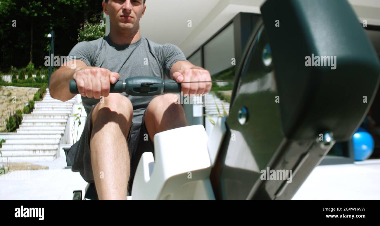 Man rowing machine home hi-res stock photography and images - Alamy