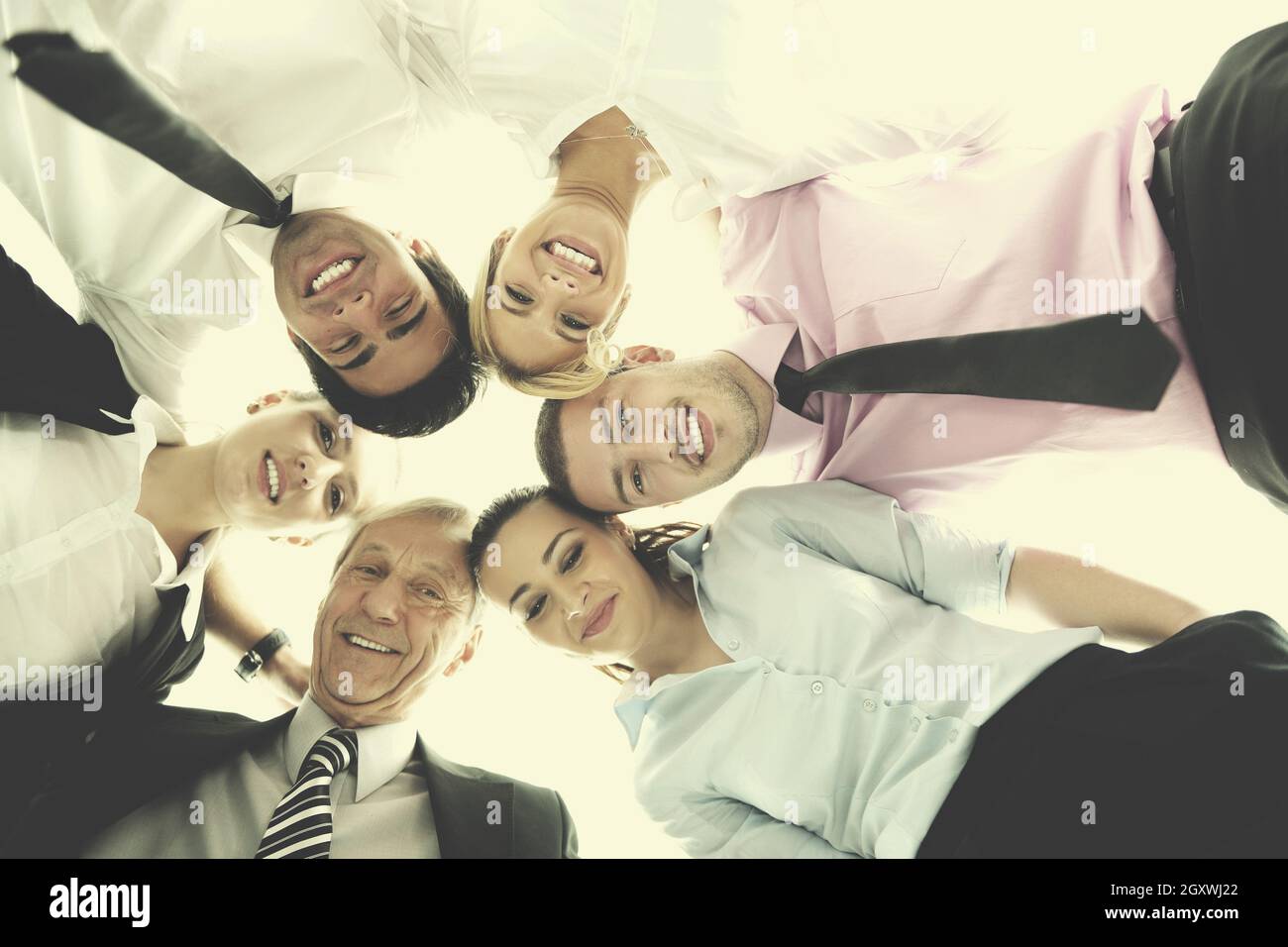 Closeup of happy business people with their heads together representing ...